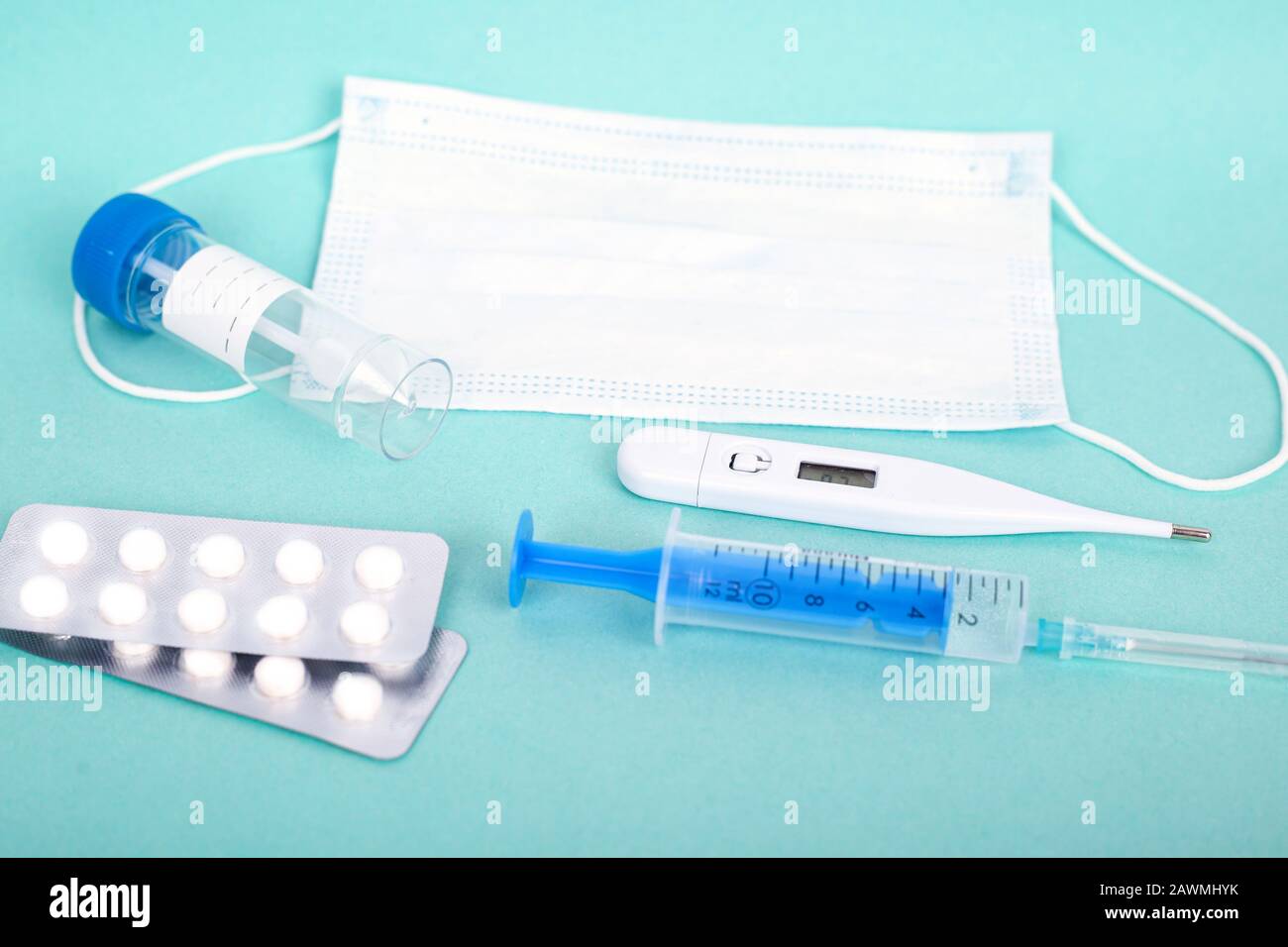 cold remedies. test tube, syringe, pills and medical mask respirator ...