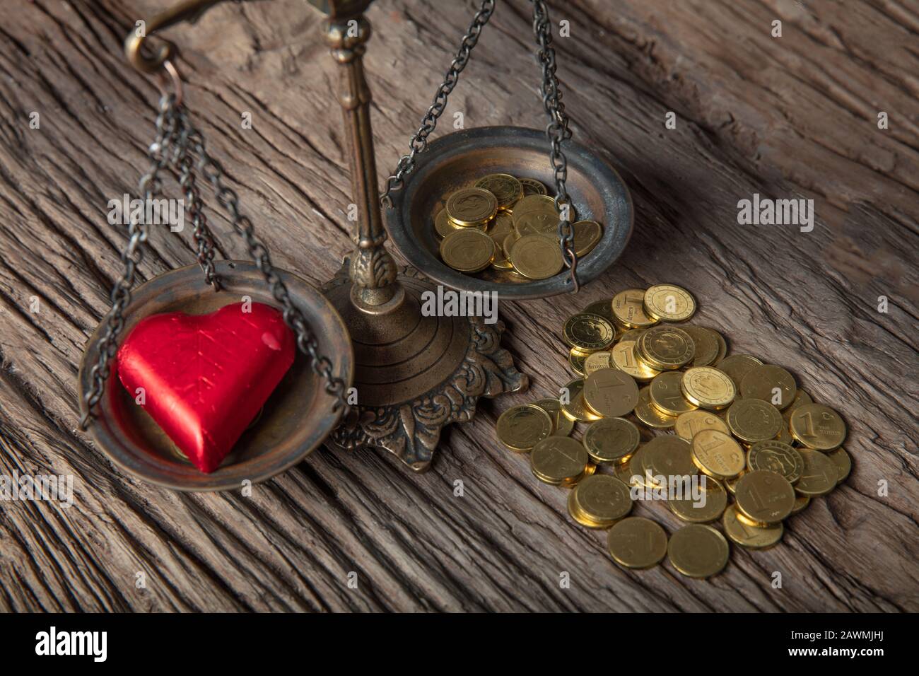 Old fashioned scale showing the advantage of love over money. Heart ...