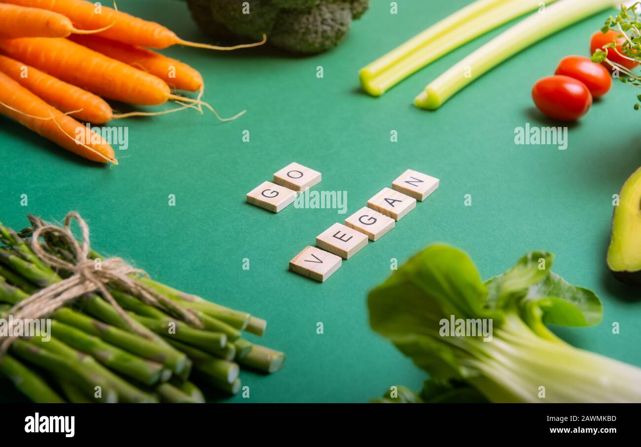 Side view set of healthy raw vegetables on the green background with ...
