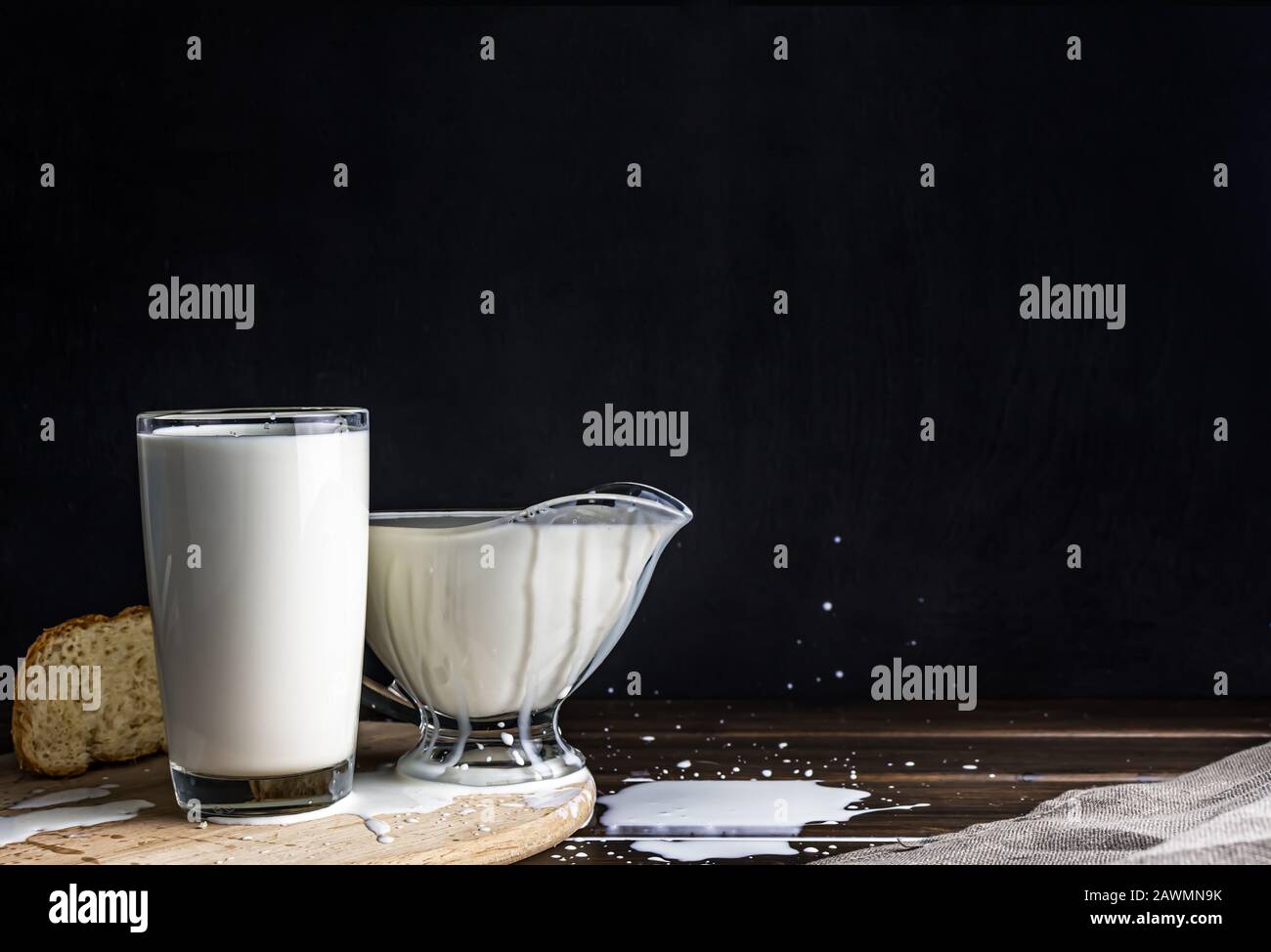 dairy products milk and cream on a black background with copy space ...