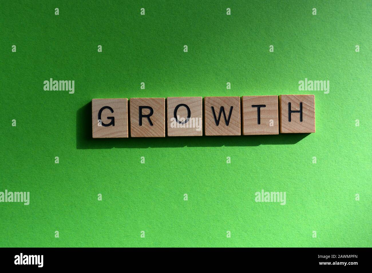 Growth, word in 3d wood alphabet letters on a green background Stock ...