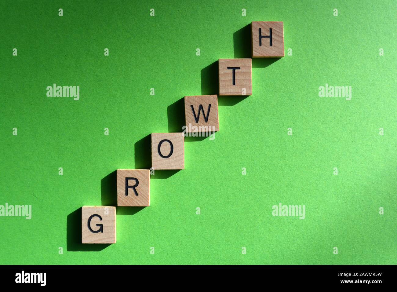Growth, word in 3d wood alphabet letters on a green background Stock ...