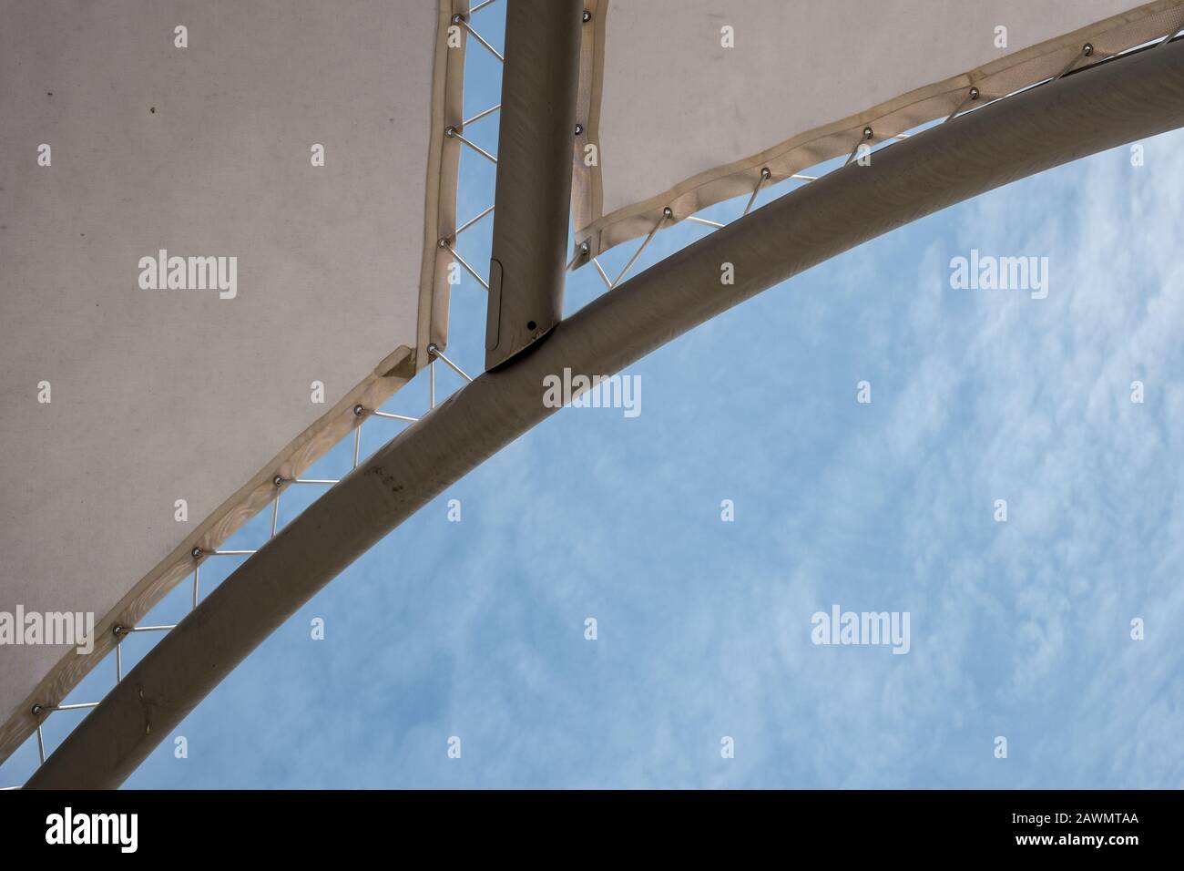 Awnings in sails shape over cloudy sky background Stock Photo - Alamy
