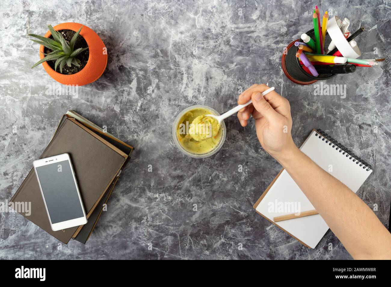 Snack at the workplace in the office. A man has lunch at the workplace ...