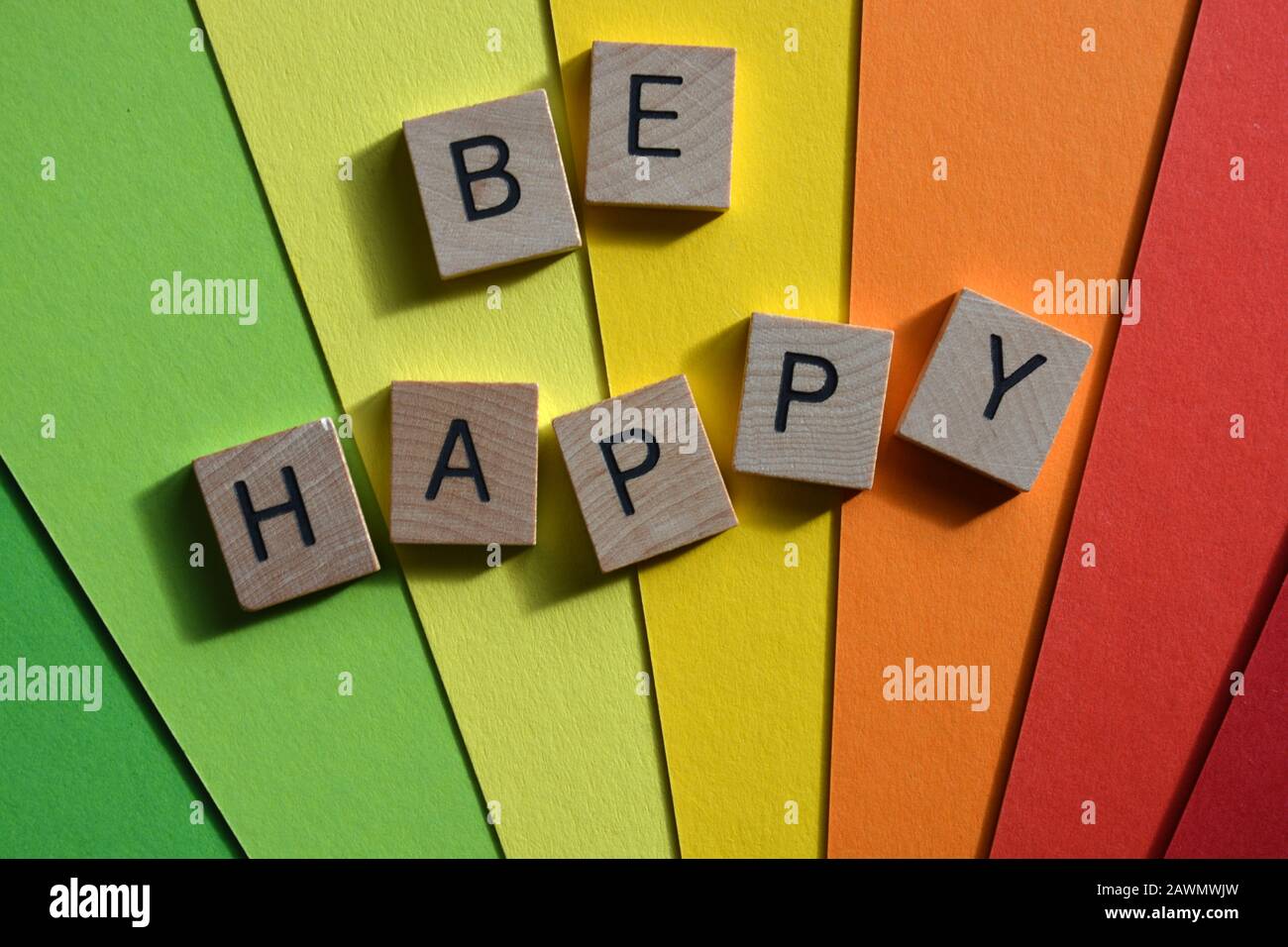 Be Happy, words in 3d wood alphabet letters a multicoloured background ...