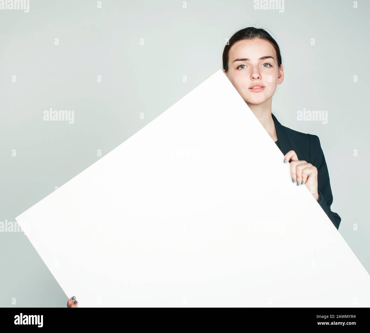 young pretty brunette girl with placard on white background wearing ...