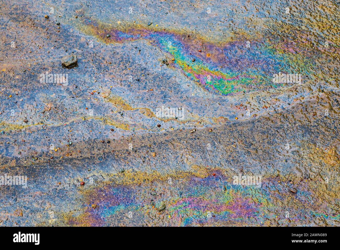 Colorful fuel and oil on an asphalt texture showing enviromental ...