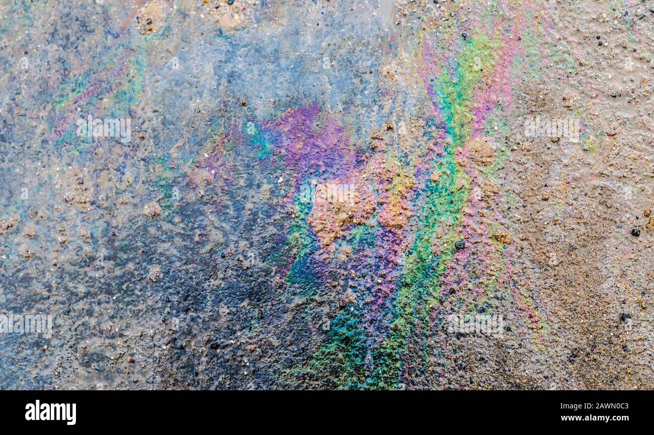Colorful fuel and oil on an asphalt texture showing enviromental ...