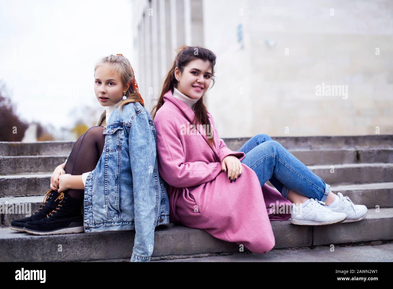young happy students teenagers at university building on stairs ...