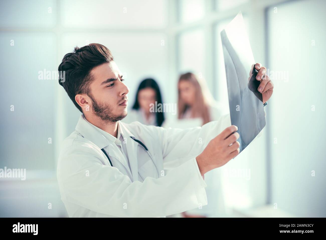 successful pediatrician standing in the hallway of the medical center ...
