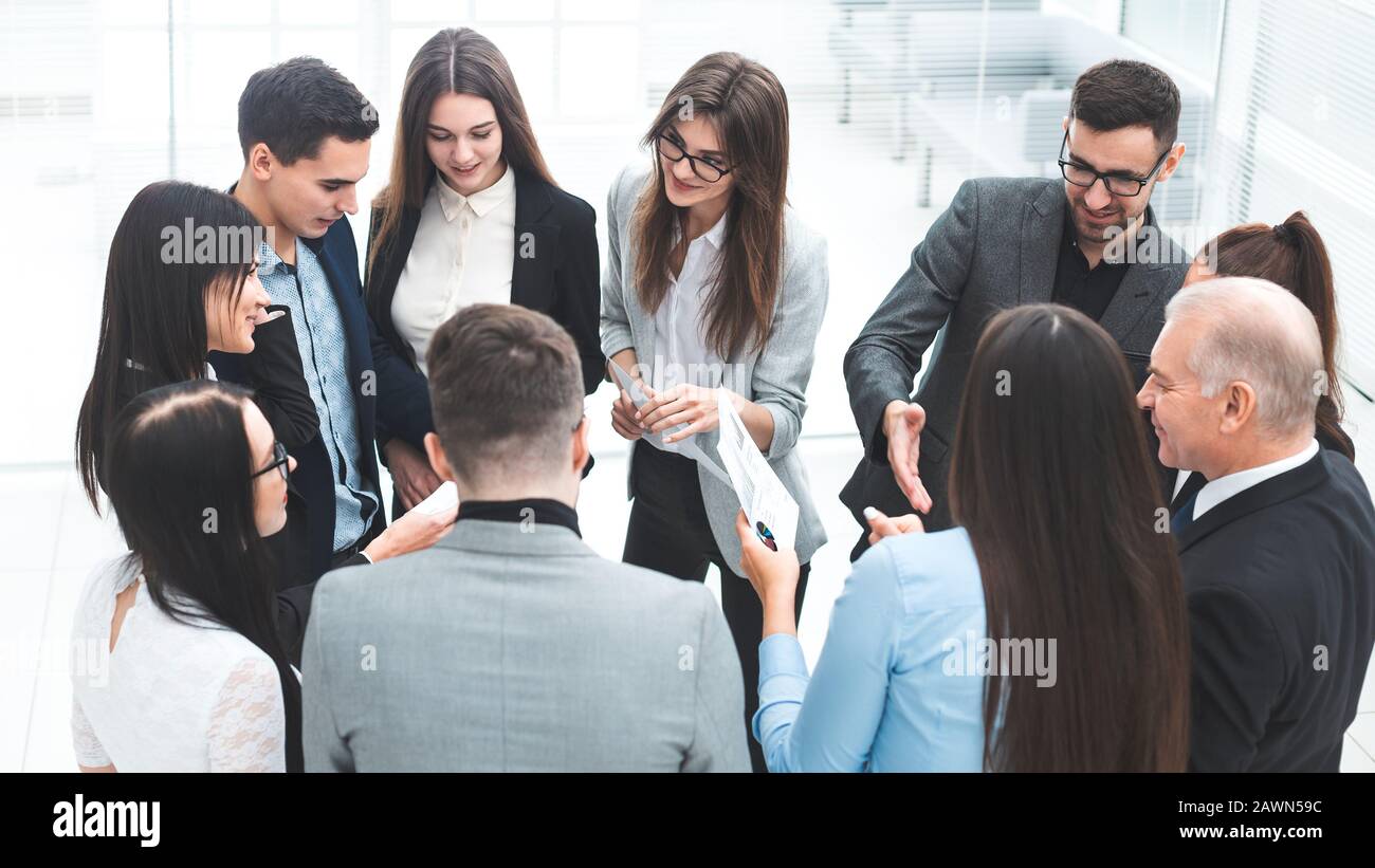 boss and a group of employees discussing business documents Stock Photo ...