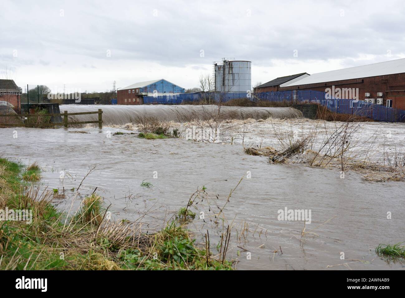 Storm ciara, River irwell bursts its banks with industrial buildings in ...