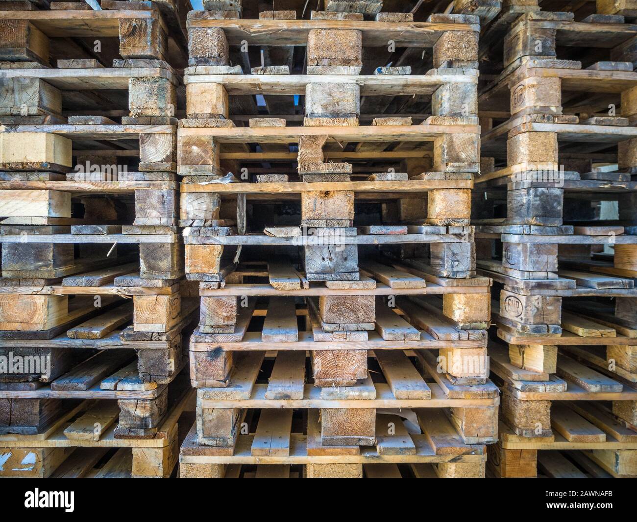 Pile of wooden palettes in a factory during daytime Stock Photo - Alamy