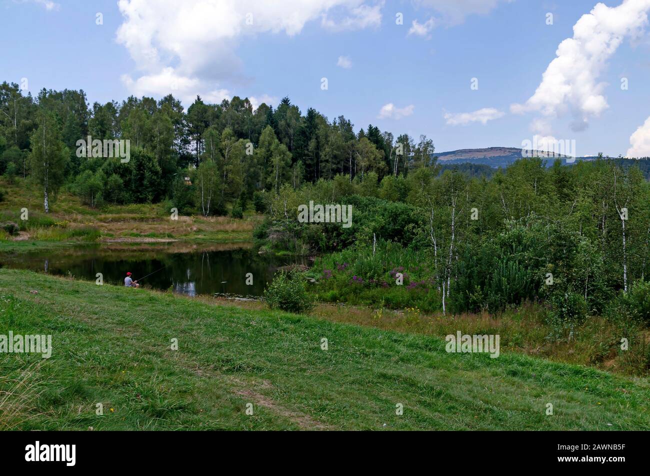 Fishing in the waters of Vlasina Lake between anchored floating island ...