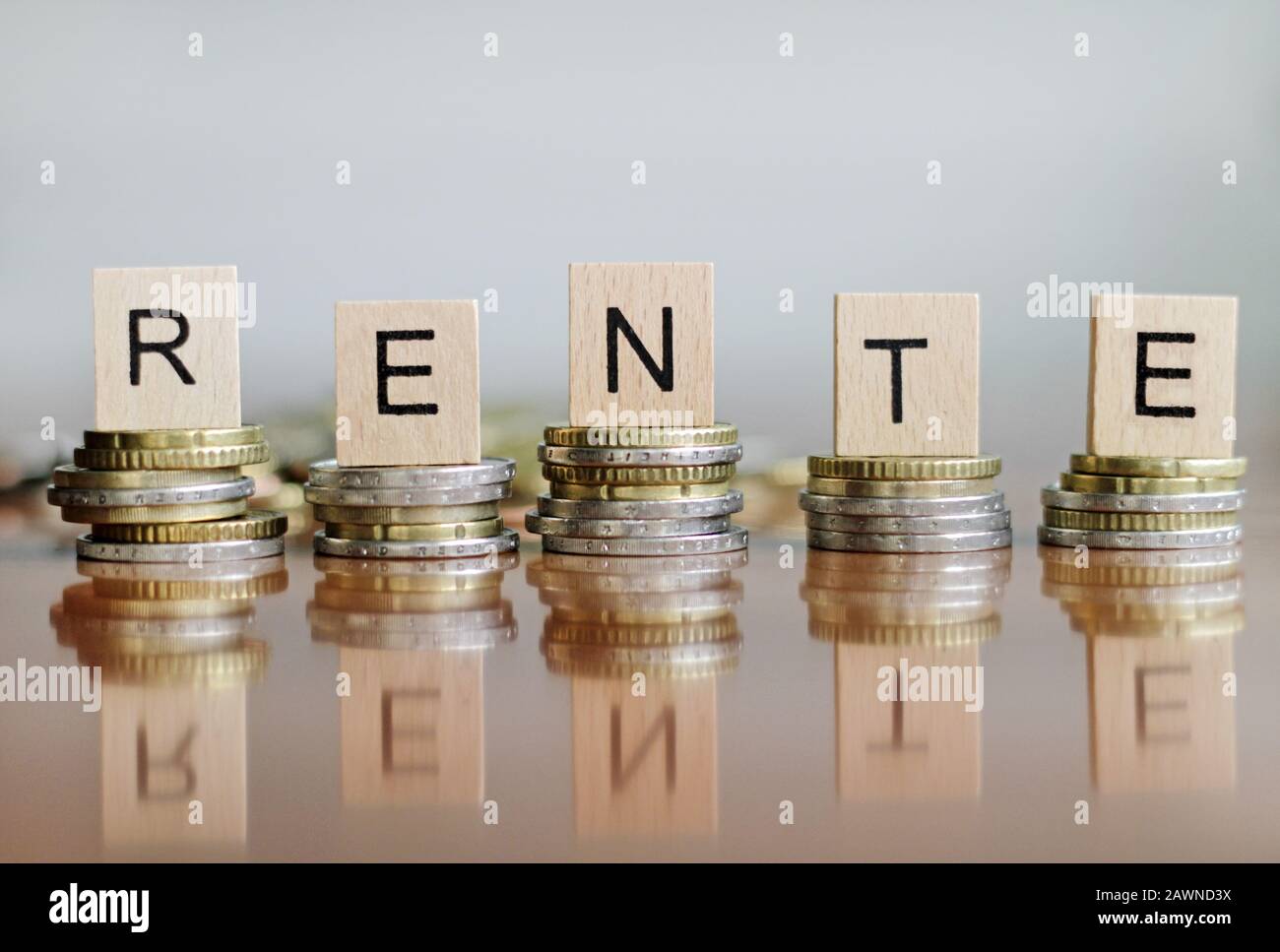 Letters of the word Rente put on coins on square surfaces Stock Photo ...