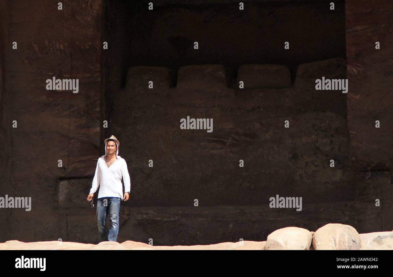 Man standing behind an ancient building during daytime Stock Photo - Alamy