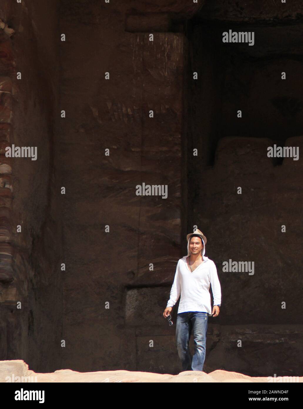 Man standing behind an ancient building during daytime Stock Photo - Alamy