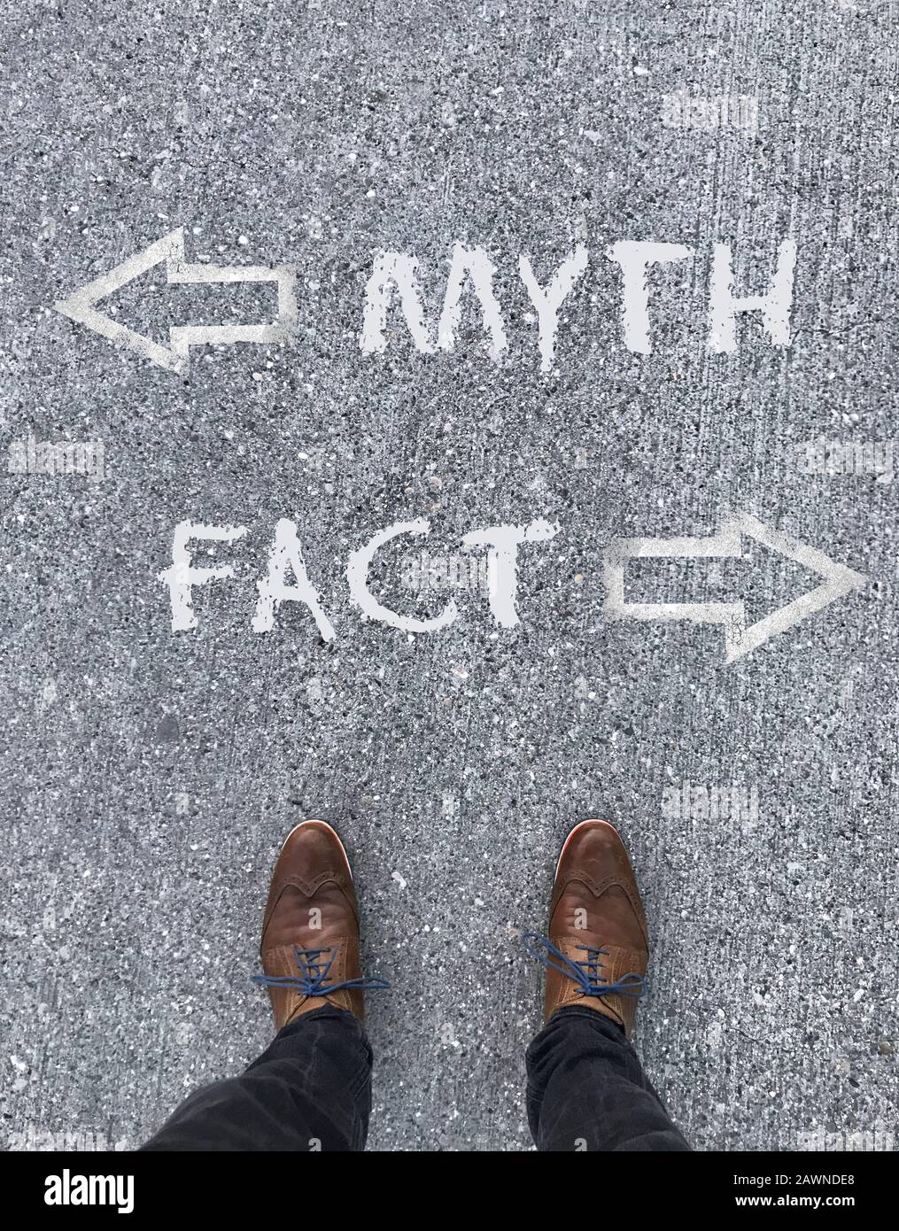 Words Myth, Fact and two arrows on the ground in front of a man's shoes ...