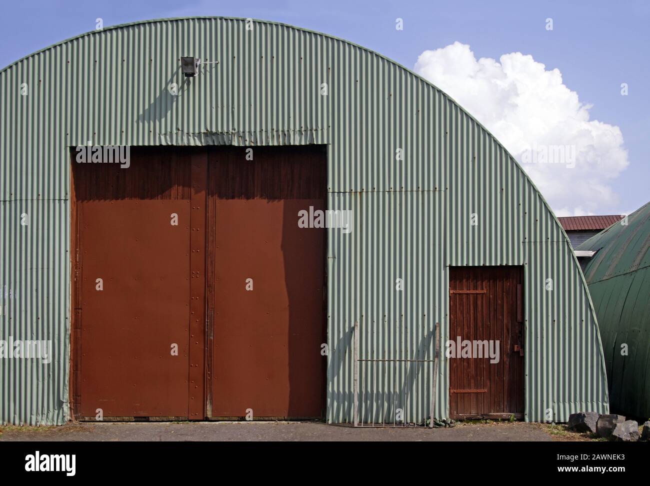 Circular building with two large doors during daytime Stock Photo - Alamy