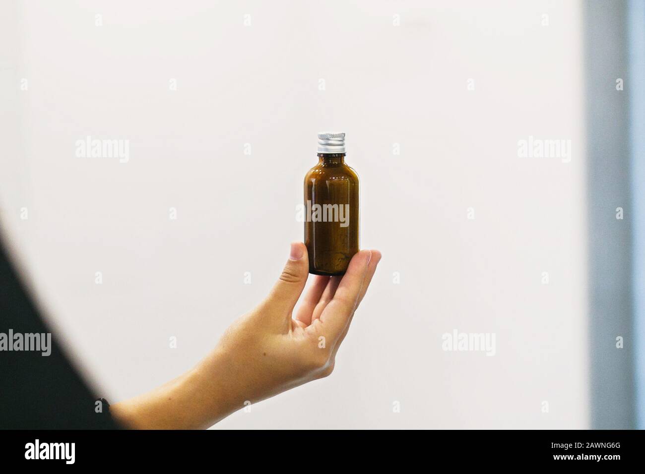 Hand holding ayurveda ubtan powder in glass in modern bathroom on ...