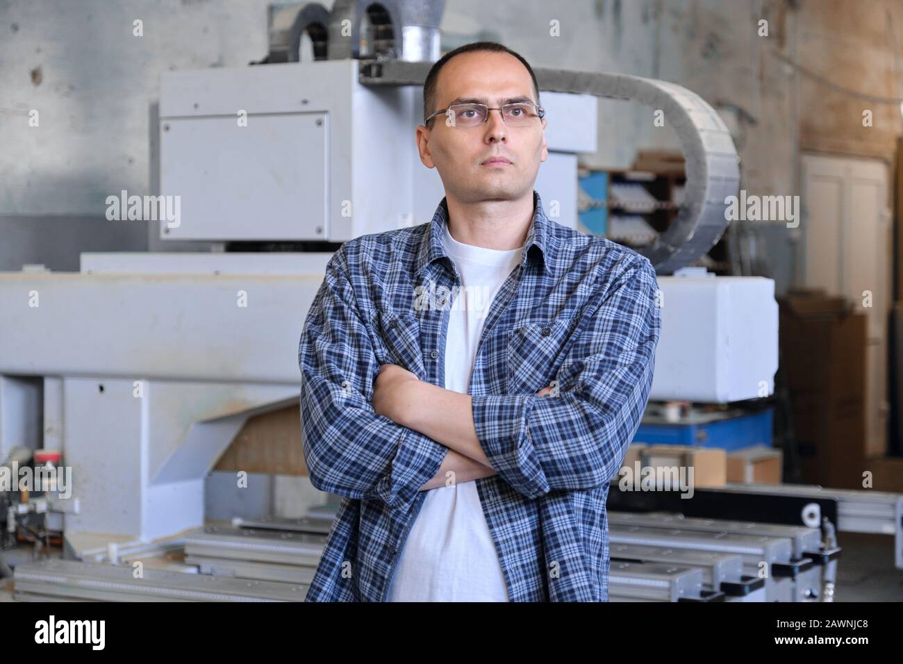 Portrait of industrial worker, man with arms crossed in carpentry ...