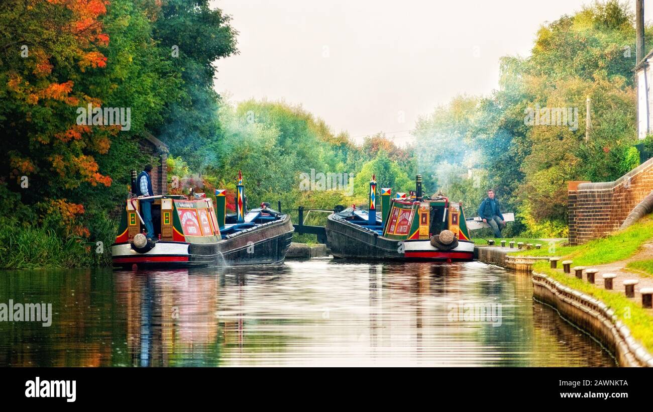 Historic working boats entering a lock on the Coventry Canal near ...