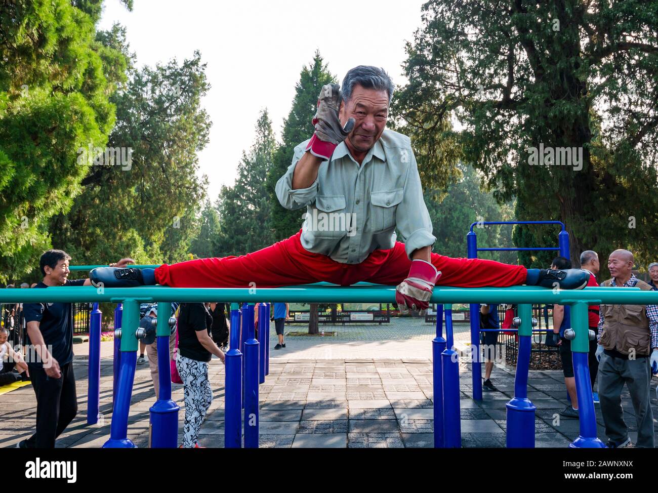 Older Chinese man exercising in outdoor gym doing the splits, Tiantan ...