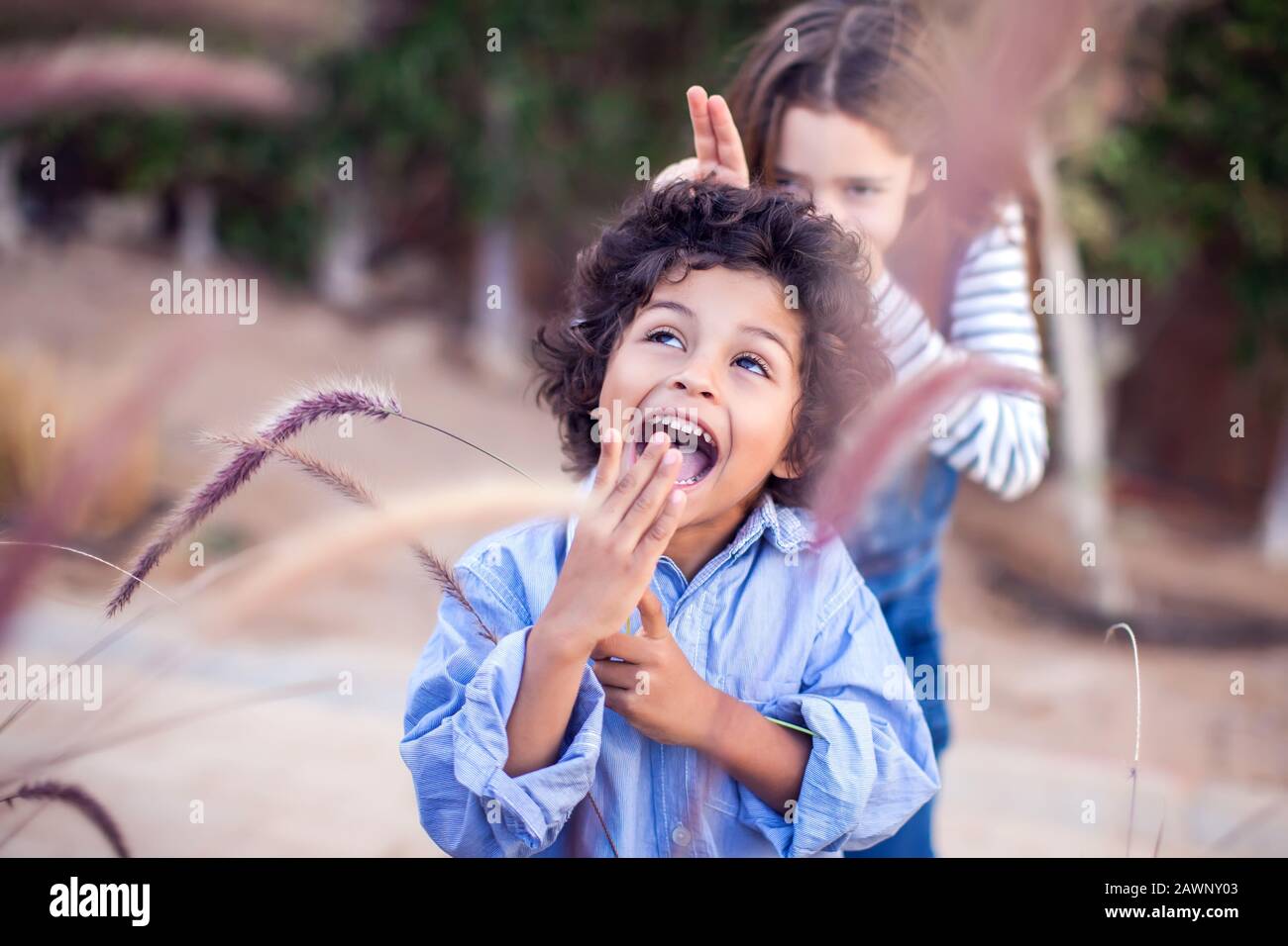 Two happy kids different race boy and girl playing outdoor. Childhood ...