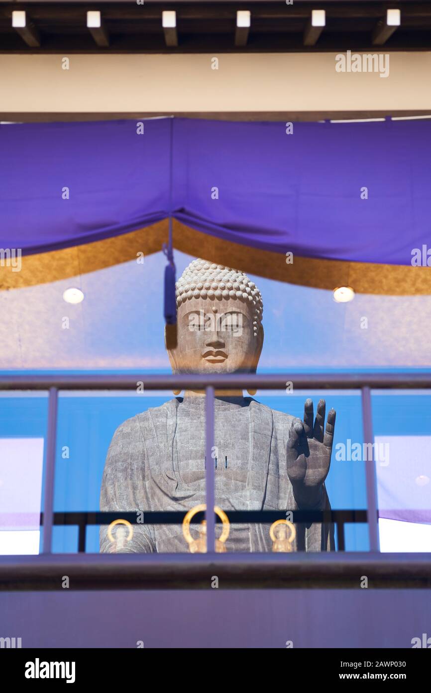 The bronze Ushiku Daibutsu (Great Buddha) with hands in vitarka mudra ...