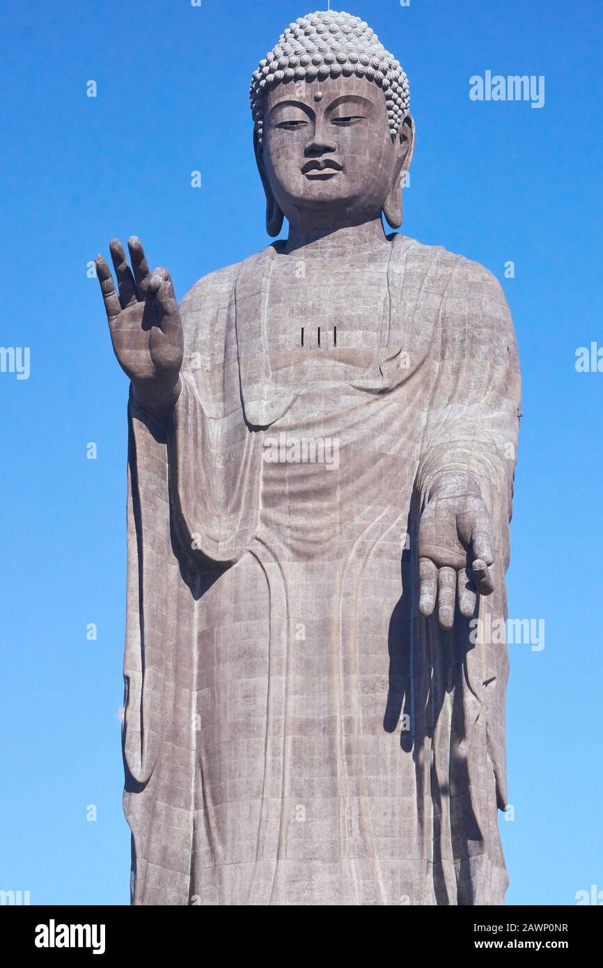 The bronze Ushiku Daibutsu (Great Buddha) with hands in vitarka mudra ...