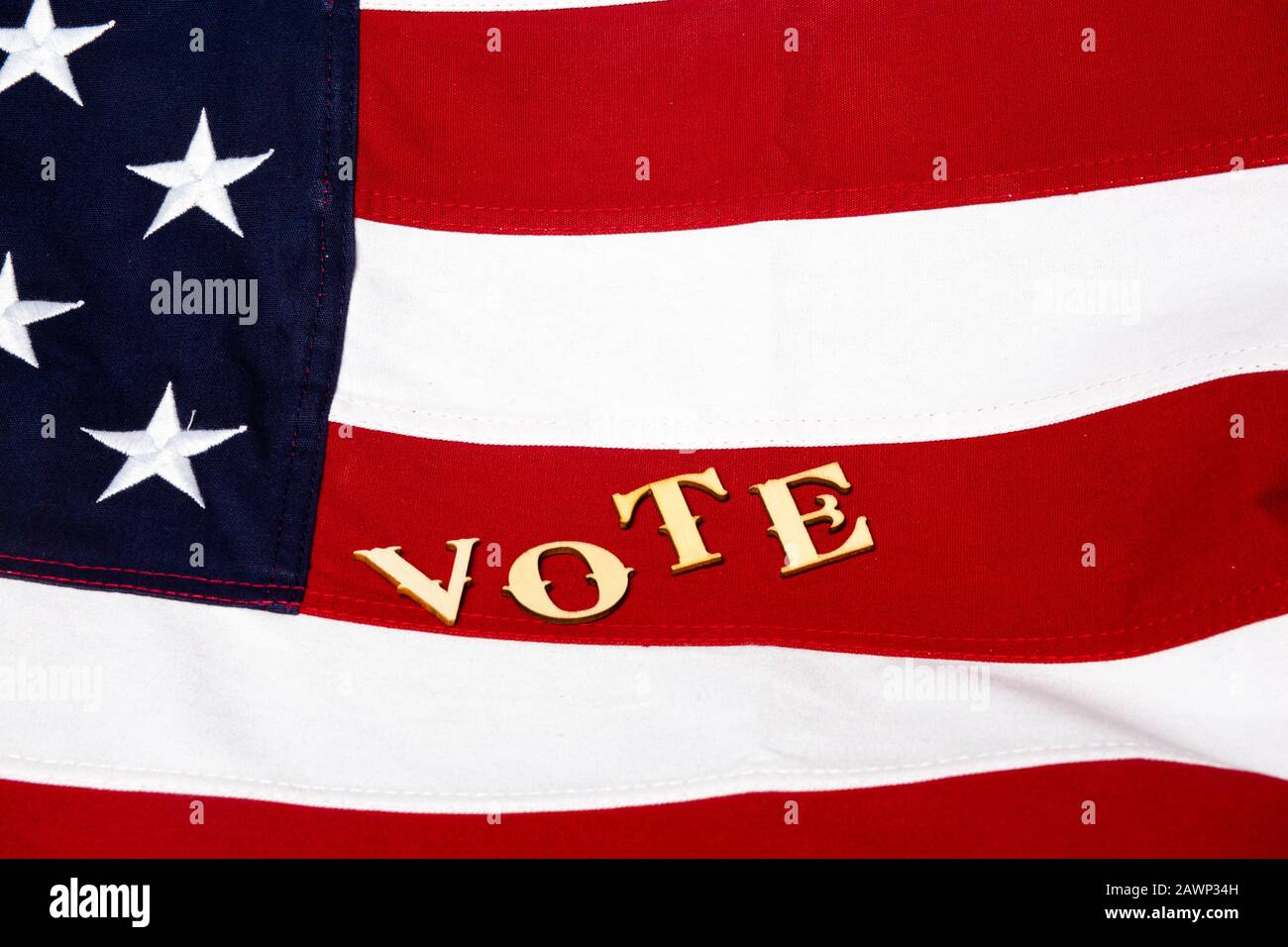 Close up of the USA flag with letters vote staggered on a red stripe ...