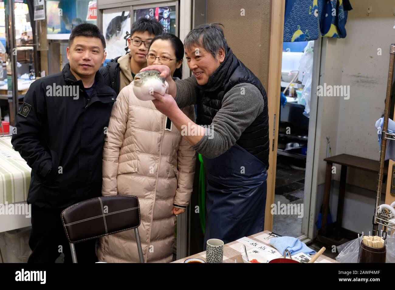 A Puffer fish being held up in Kuromon Ichiba Market in Osaka, Japan ...