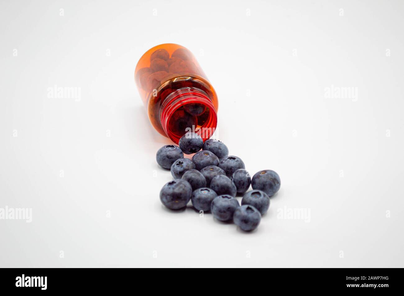 Medicine prescription bottle with fresh blueberries falling out Stock ...