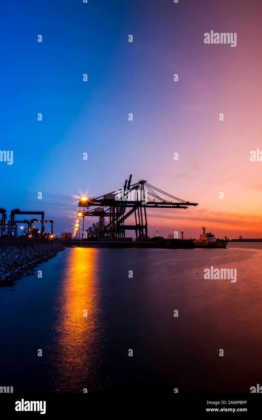 Freight dock of container crane at night Stock Photo - Alamy