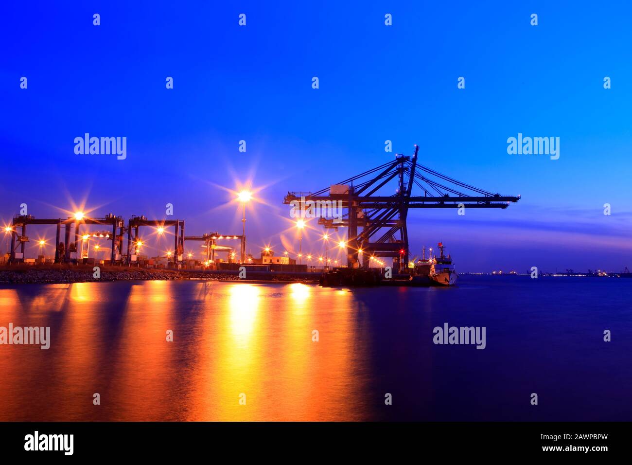 Freight dock of container crane at night Stock Photo - Alamy