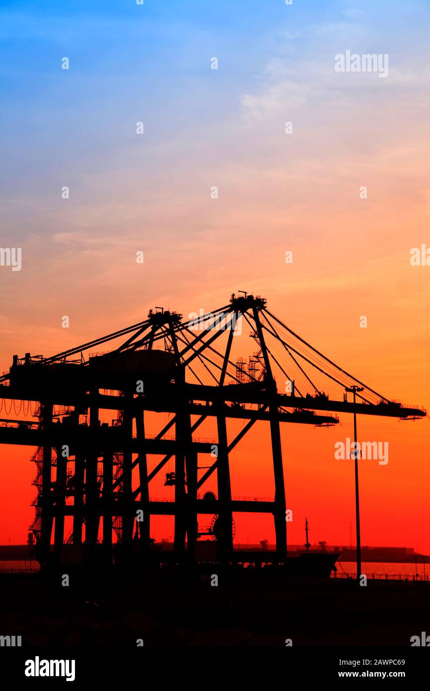 in the evening，Freight dock of container crane Stock Photo - Alamy