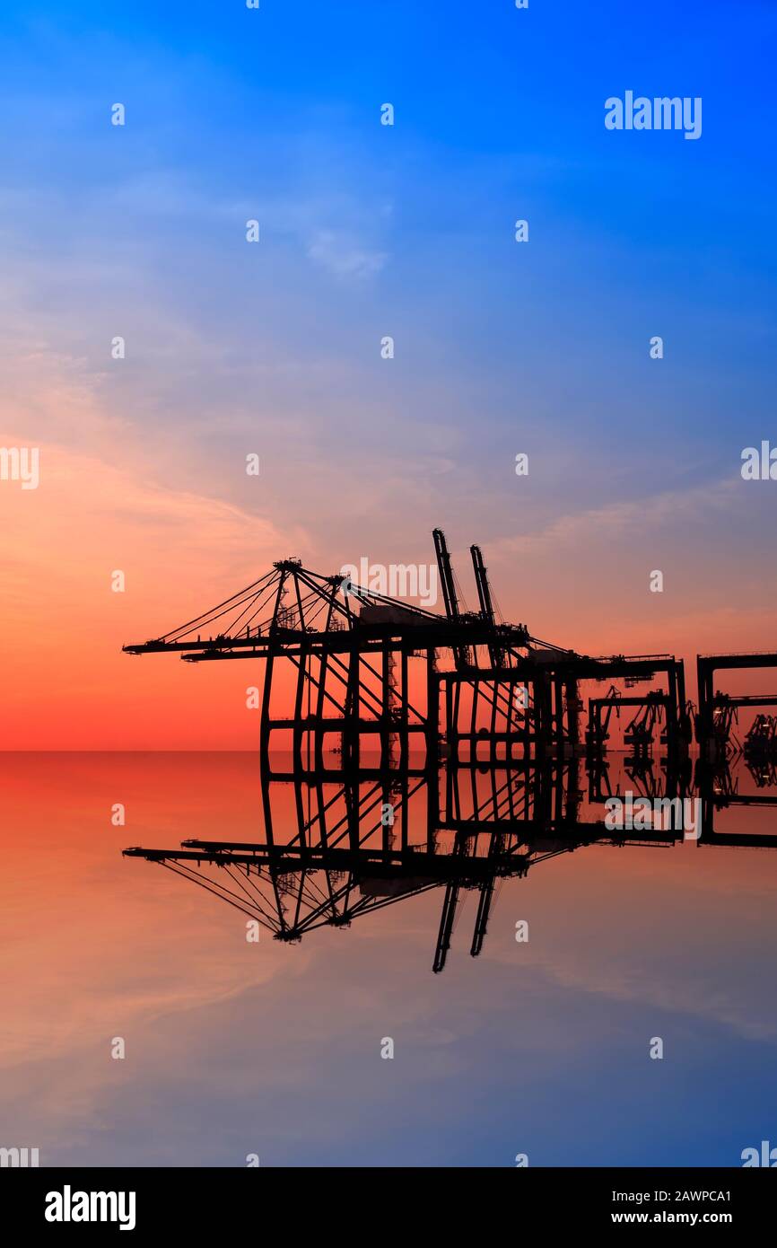 in the evening，Freight dock of container crane Stock Photo - Alamy