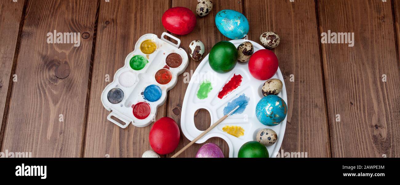 Colored eggs and paint on a wooden table, Easter background Stock Photo ...