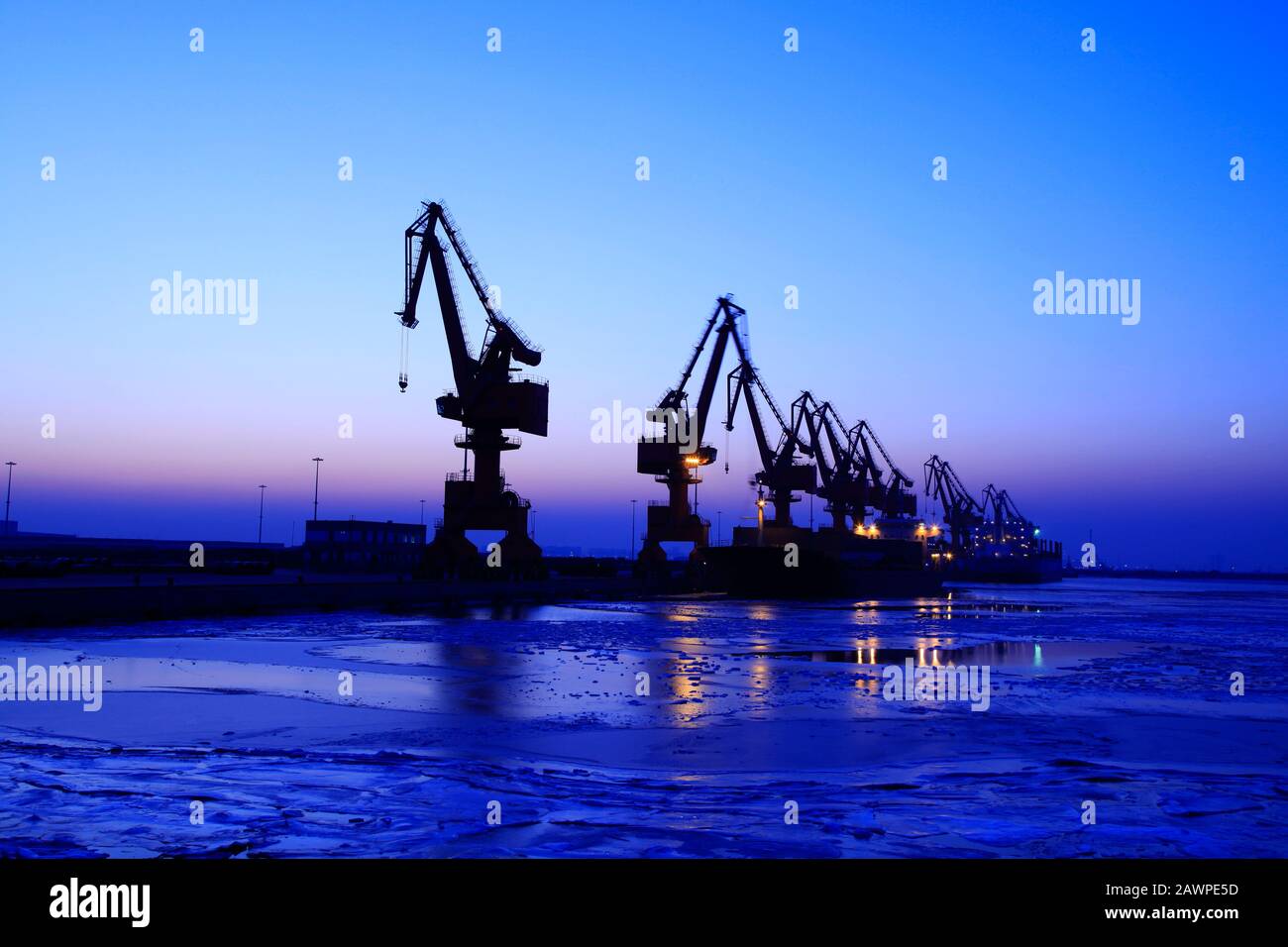 Cargo wharf crane at night Stock Photo - Alamy