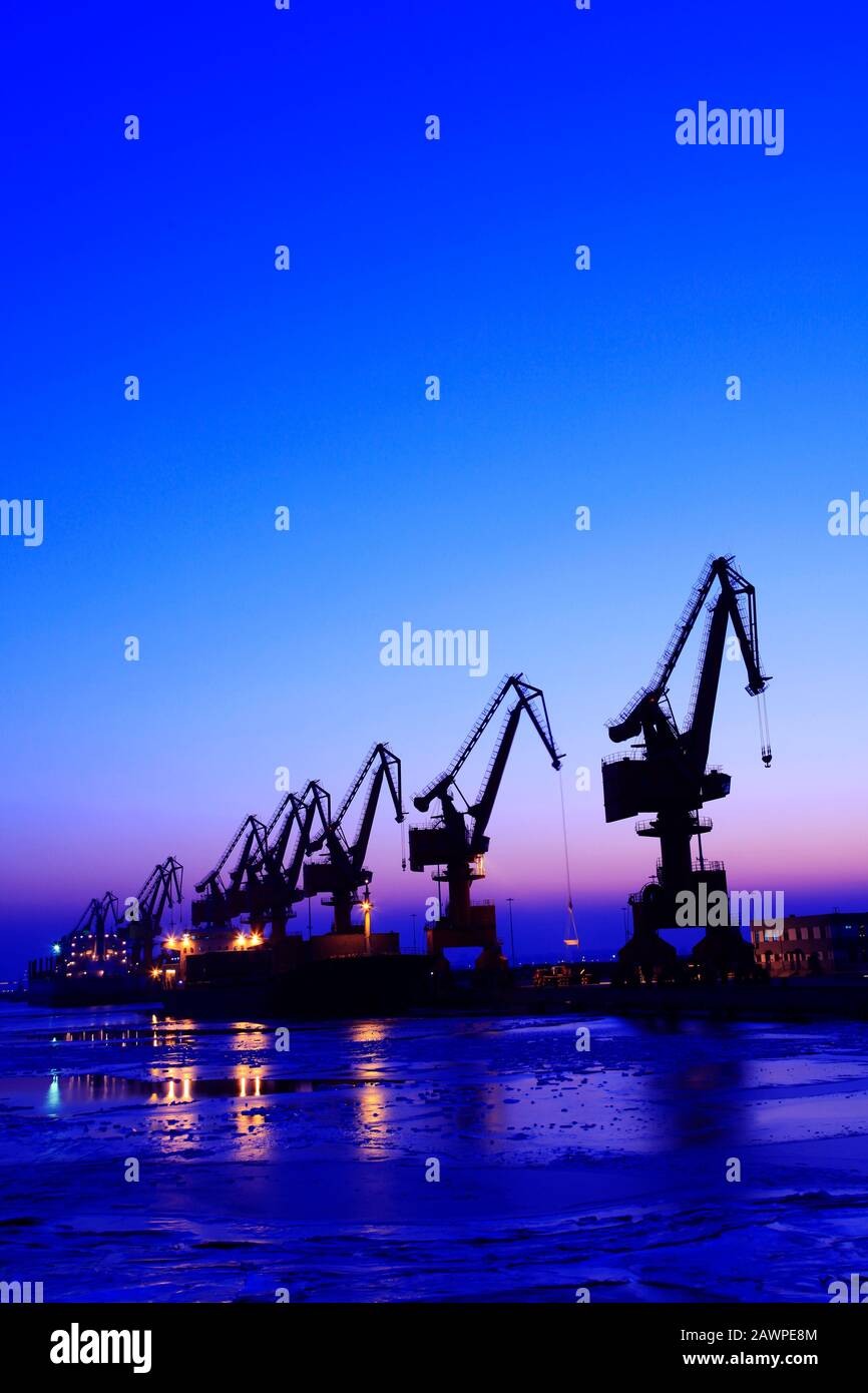 Cargo wharf crane at night Stock Photo - Alamy