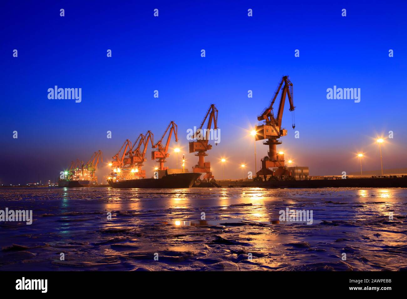 Cargo wharf crane at night Stock Photo - Alamy