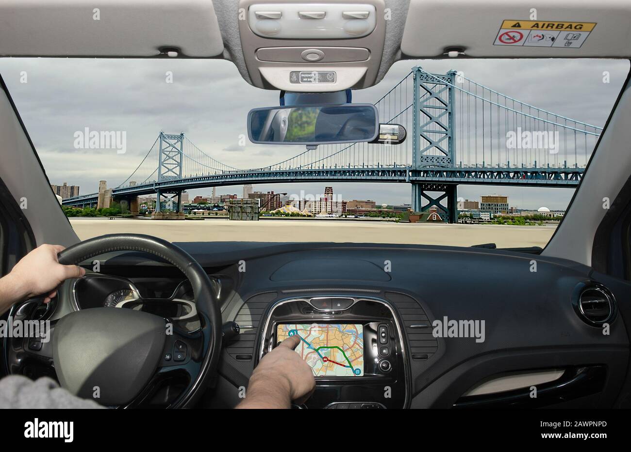 Driving a car while using the touch screen of a GPS navigation system ...