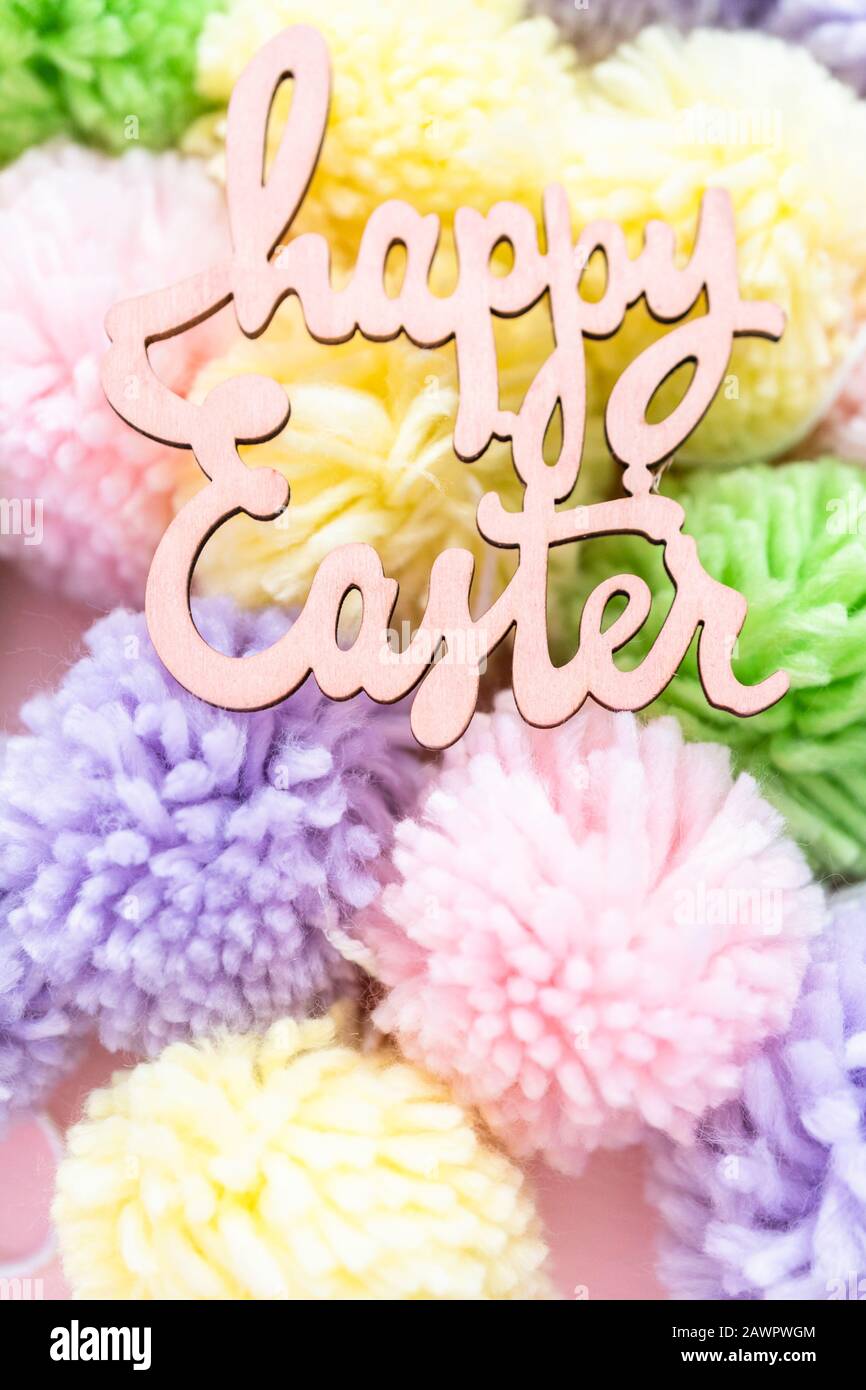 Happy Easter sign and pastel color pom poms on a pink background Stock ...
