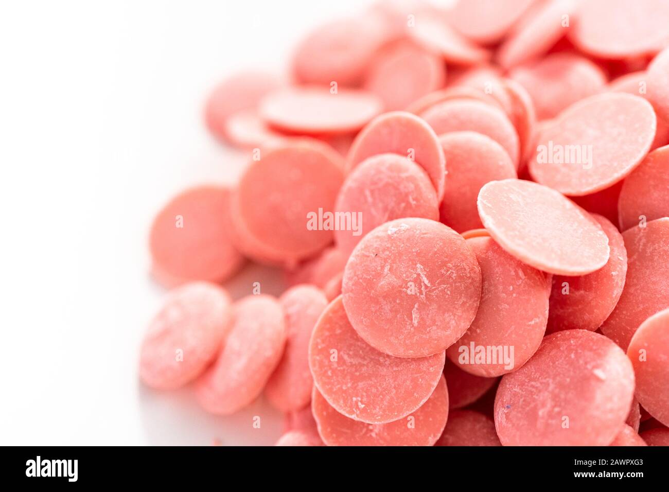 Pink round chocolate chips for melting chocolate shapes on a white ...