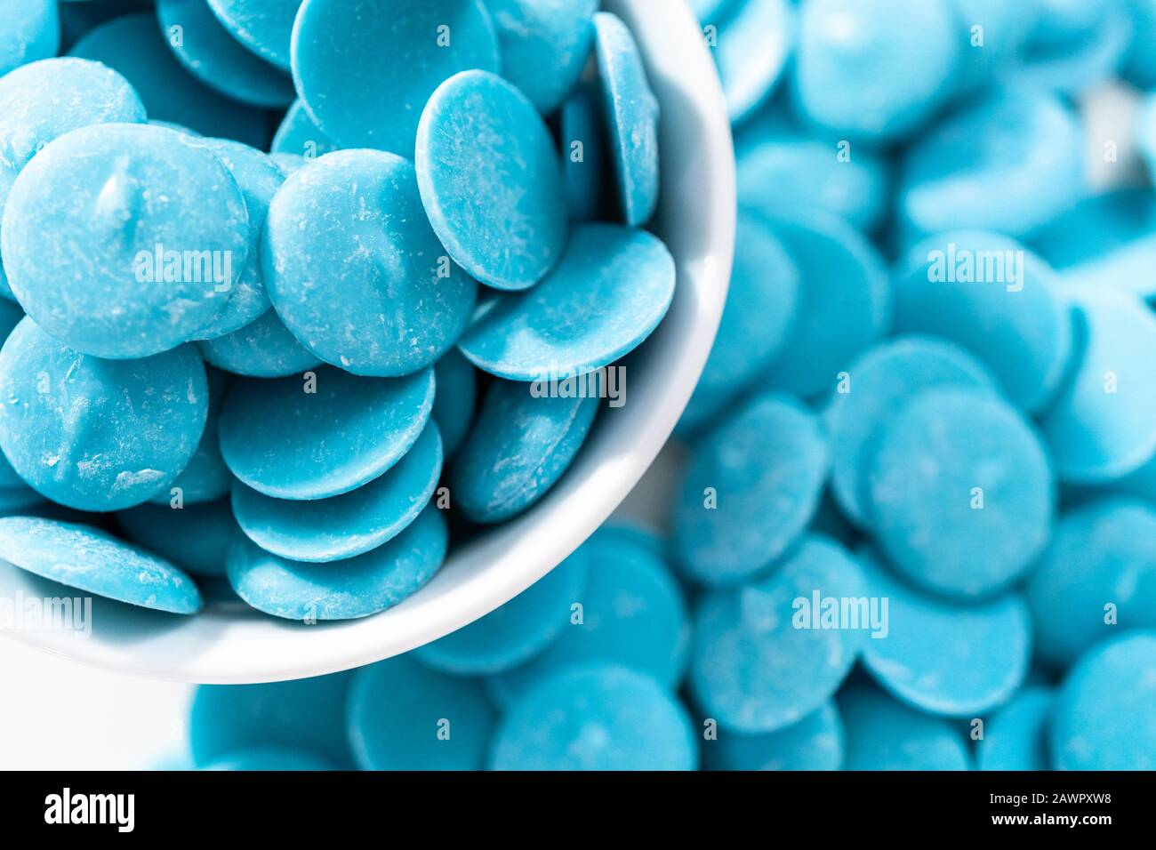 Blue round chocolate chips for melting chocolate shapes Stock Photo - Alamy
