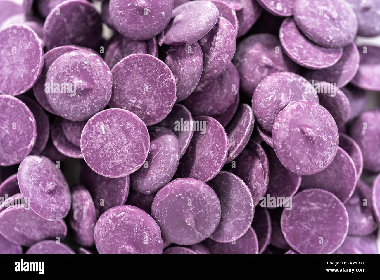 Purple round chocolate chips for melting chocolate shapes on a white ...