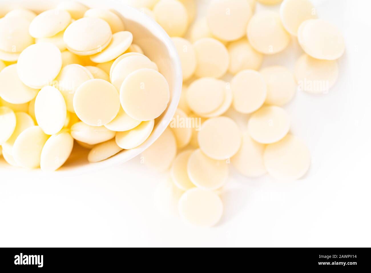 White round chocolate chips for melting chocolate shapes on a white ...