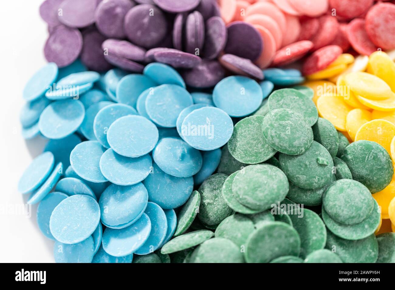 Rainbow colors of round chocolate chips for melting chocolate shapes on ...
