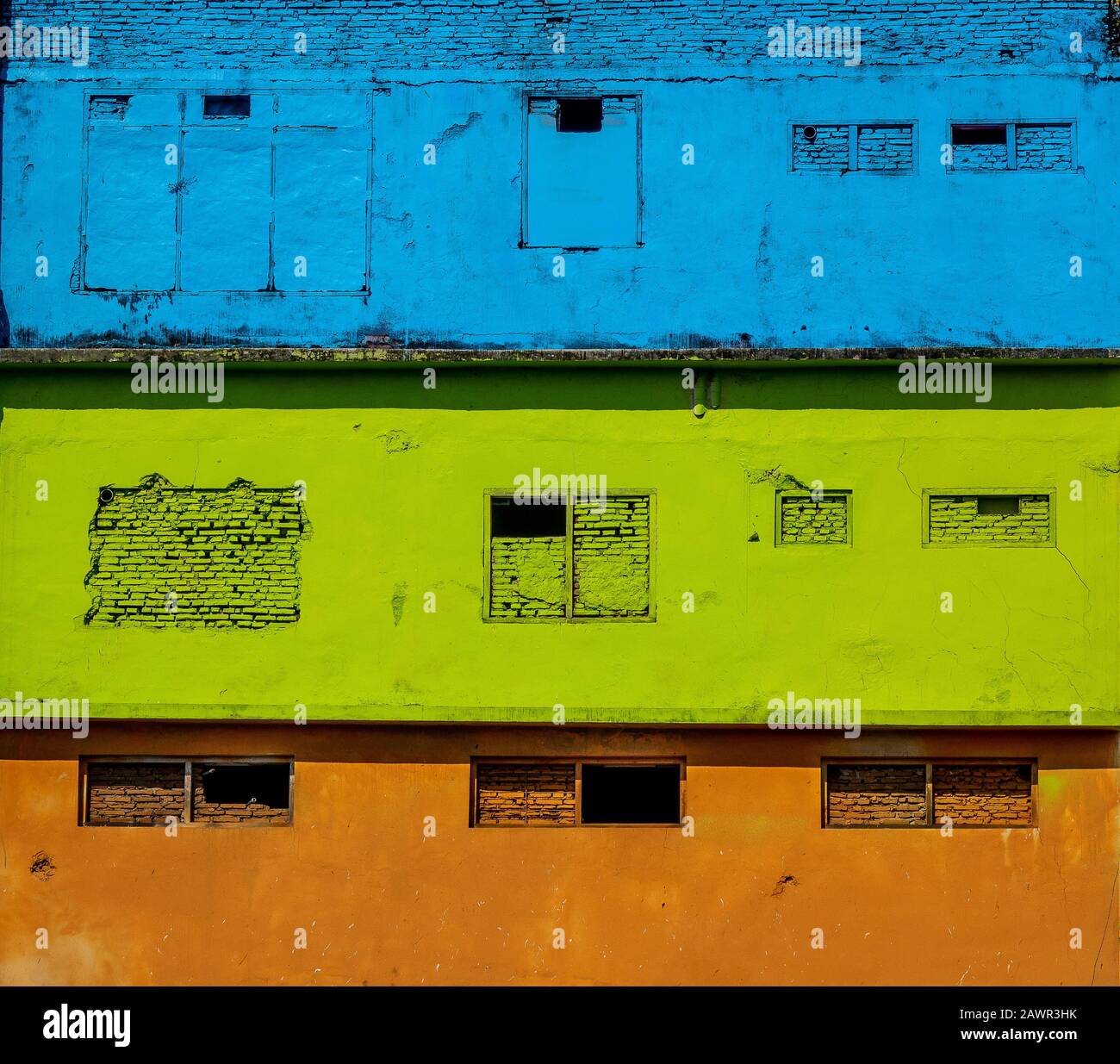 Blue, green and orange layers of the facade of an old building Stock ...