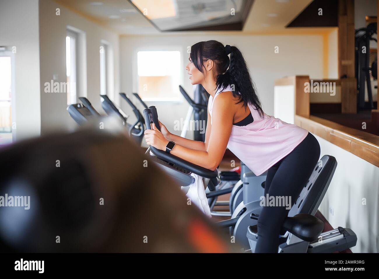 Young attractive woman doing exercises in fitness gym Stock Photo - Alamy